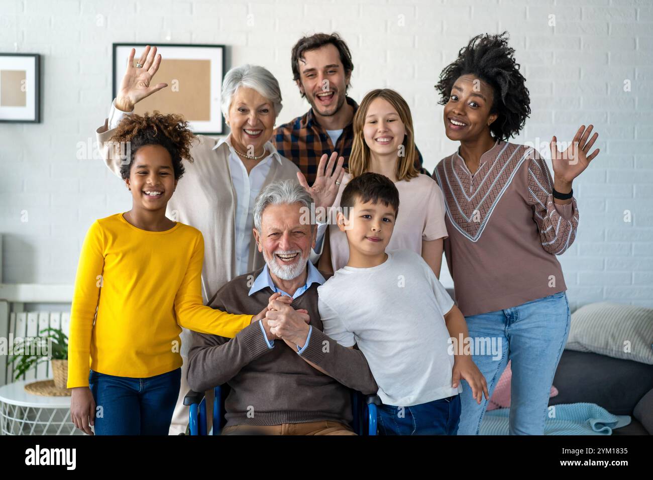 Multi generation, multiethnic family at home together, grandfather with ...