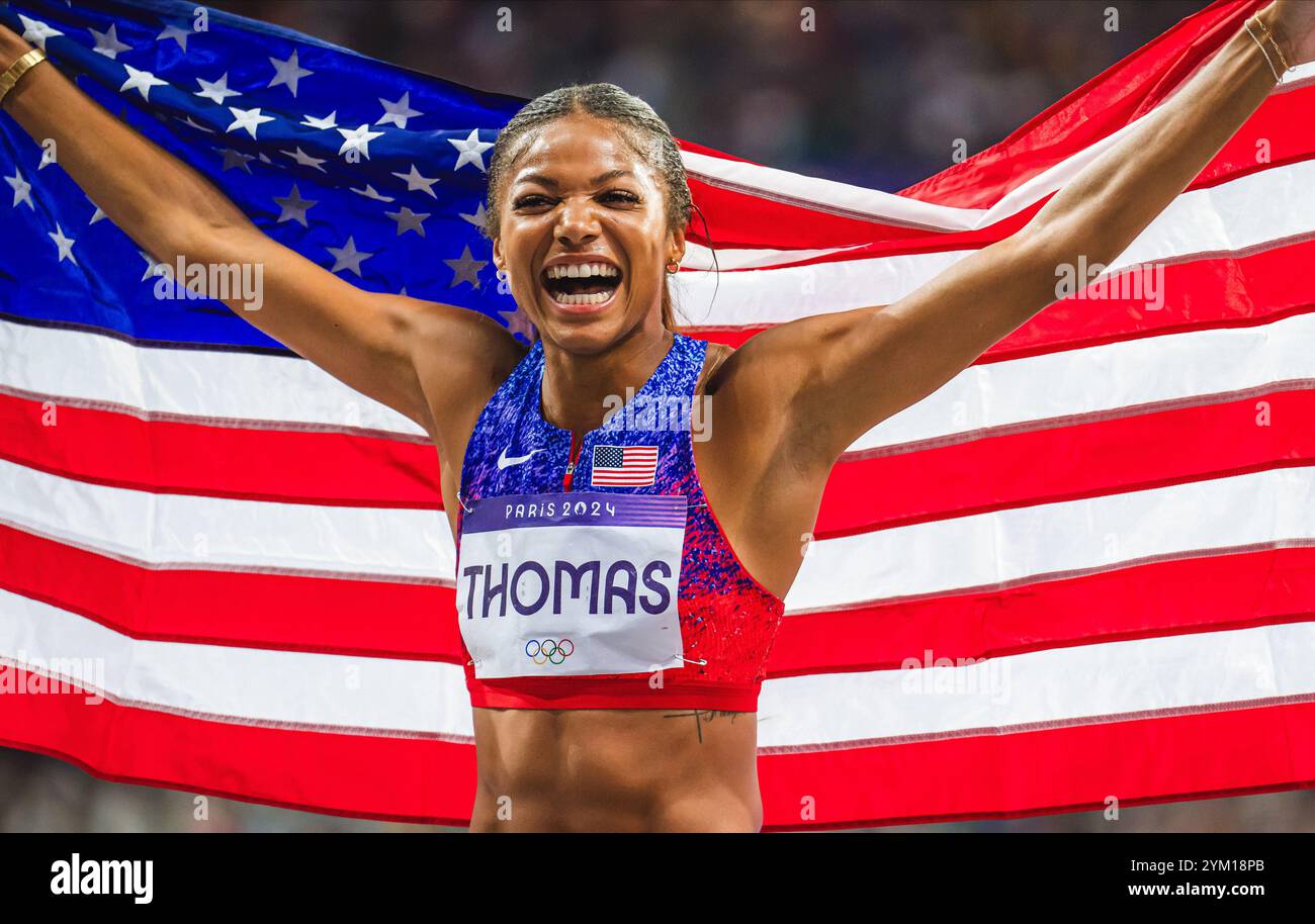 Gabrielle Thomas celebrating with her country's flag in the 200 meters ...