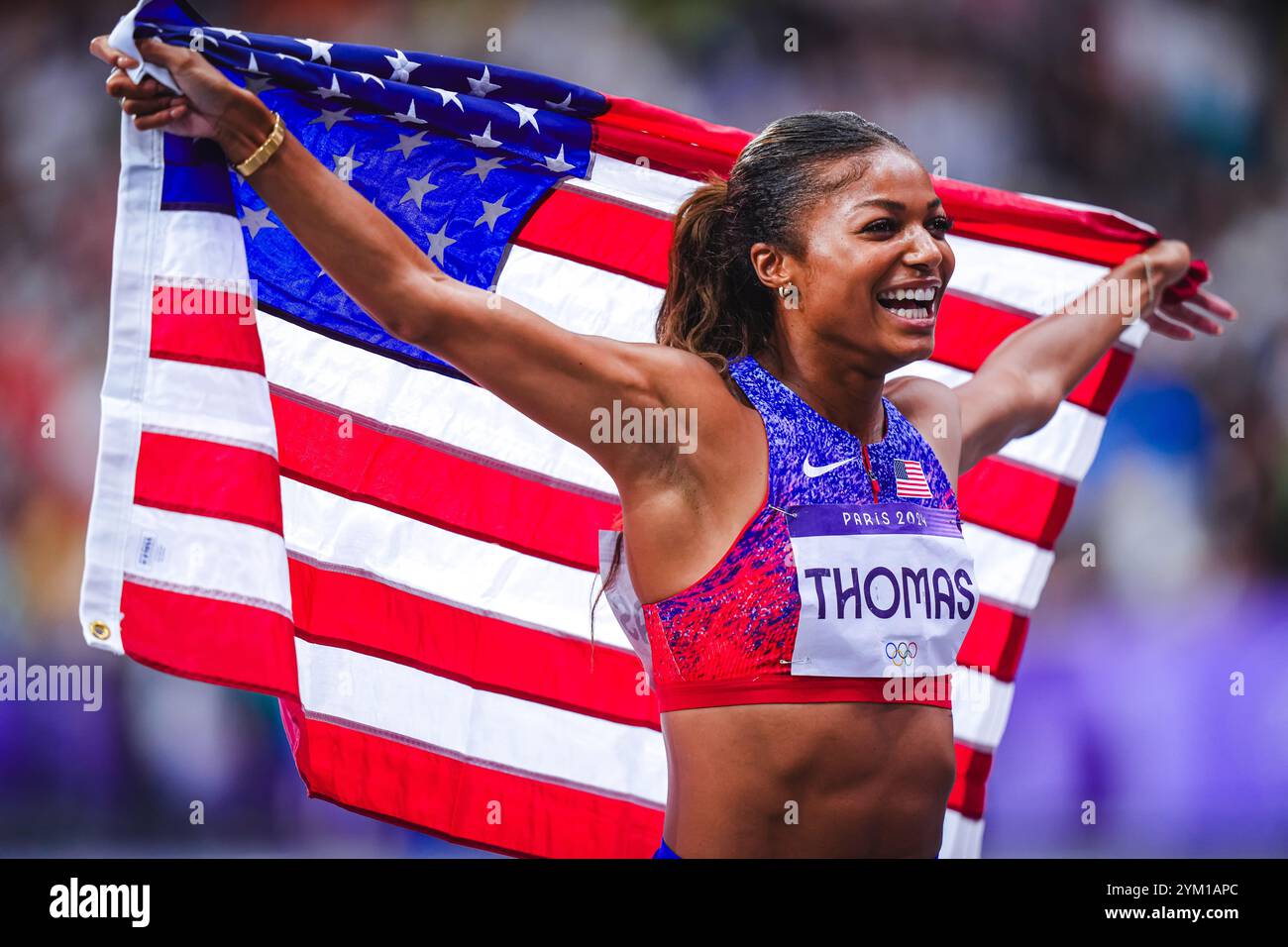 Gabrielle Thomas celebrating with her country's flag in the 200 meters ...