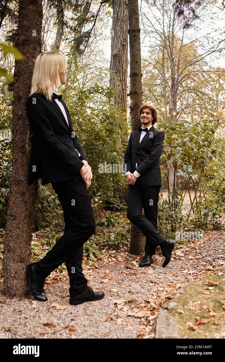 In a serene garden with lush greenery, two handsome young men dressed ...