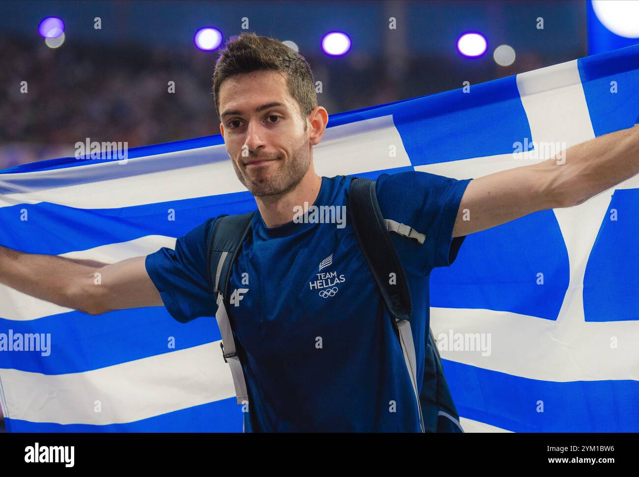 Miltiadis Tentoglu celebrating her medal with her country's flag at the ...