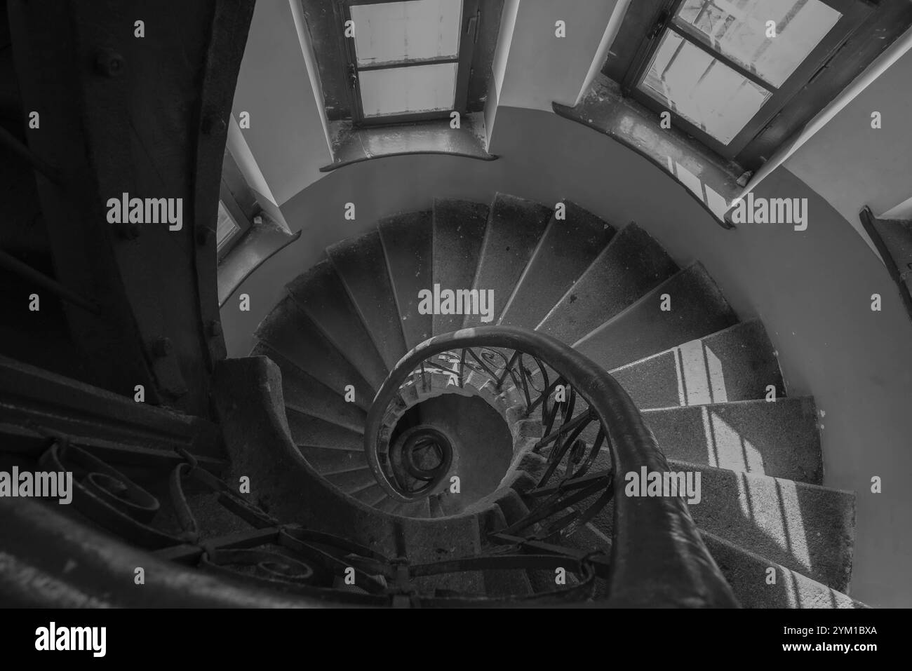 spiral staircase in an old building going down in black and white Stock ...