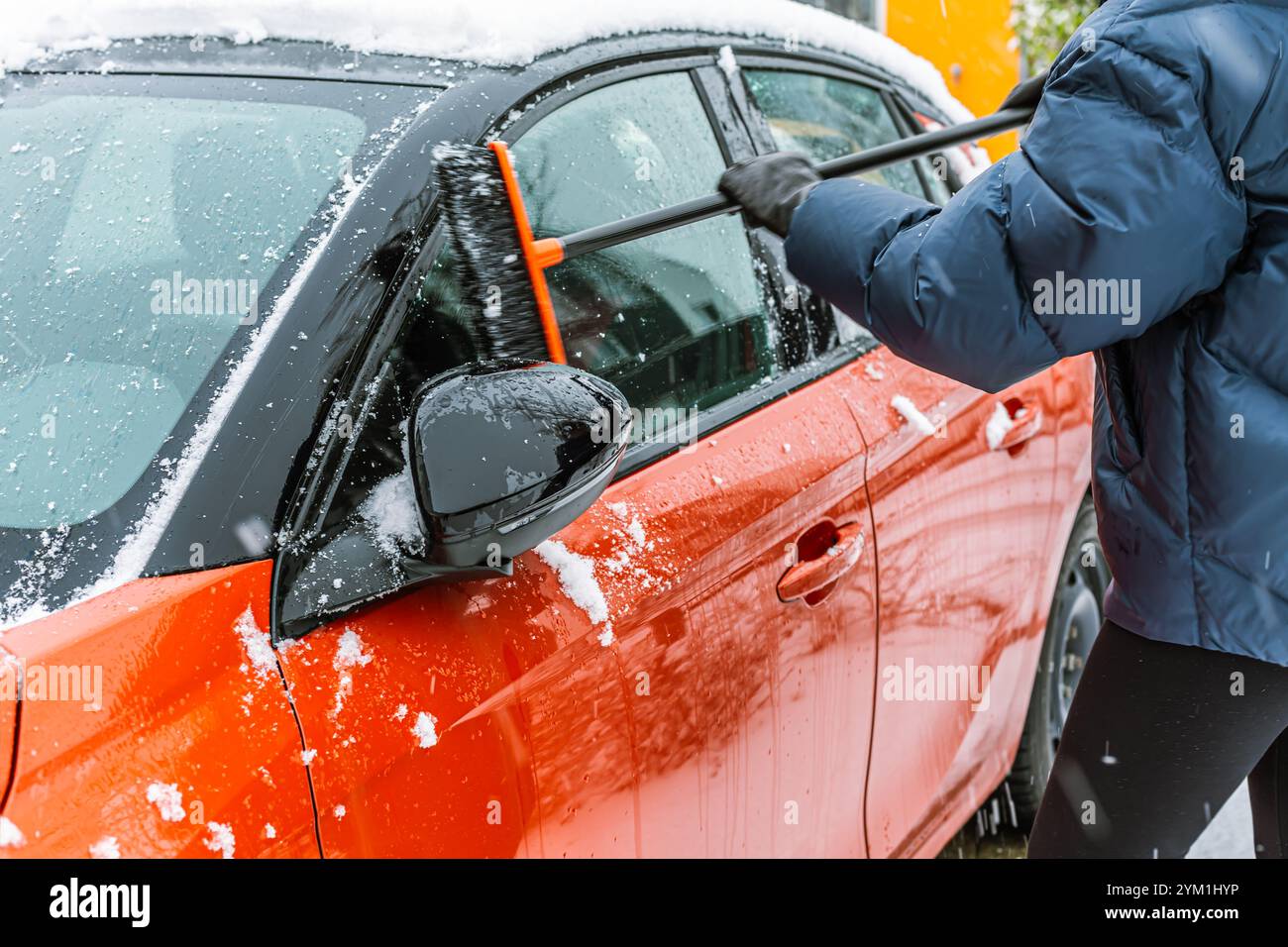 Cleaning and scraping windscreen from snow Stock Photo - Alamy
