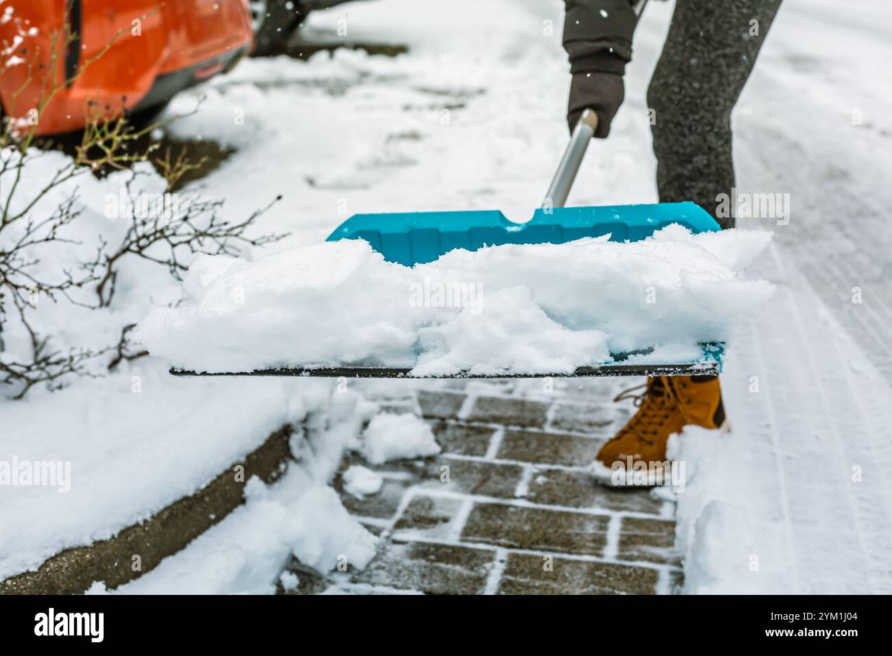 Removing snow from sidewalk, snow shoveling Stock Photo - Alamy