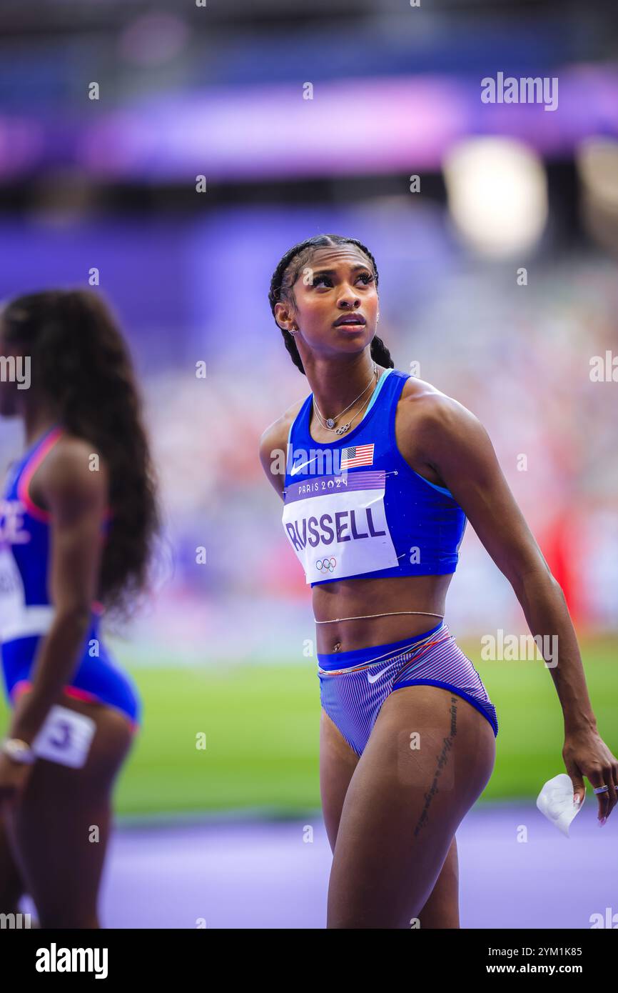 Masai Russell participating in the 100 meters hurdles at the Paris 2024 ...