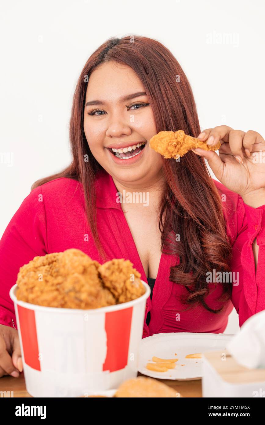 A Joyful Woman Delightfully Enjoying Some Fried Chicken with a Big ...