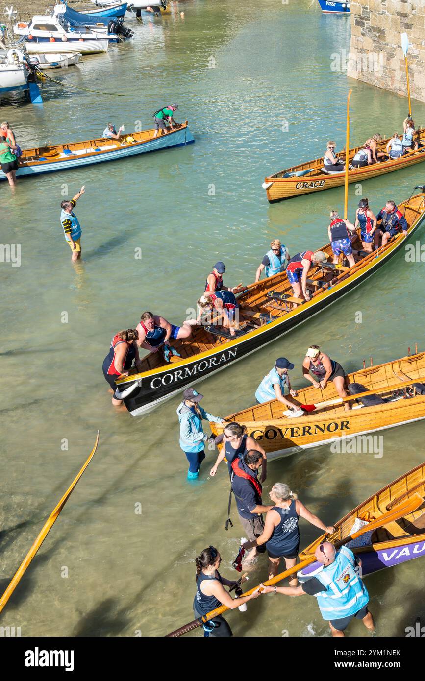 Pilot Gig crews carrying their oars waiting to board their Pilot Gigs ...