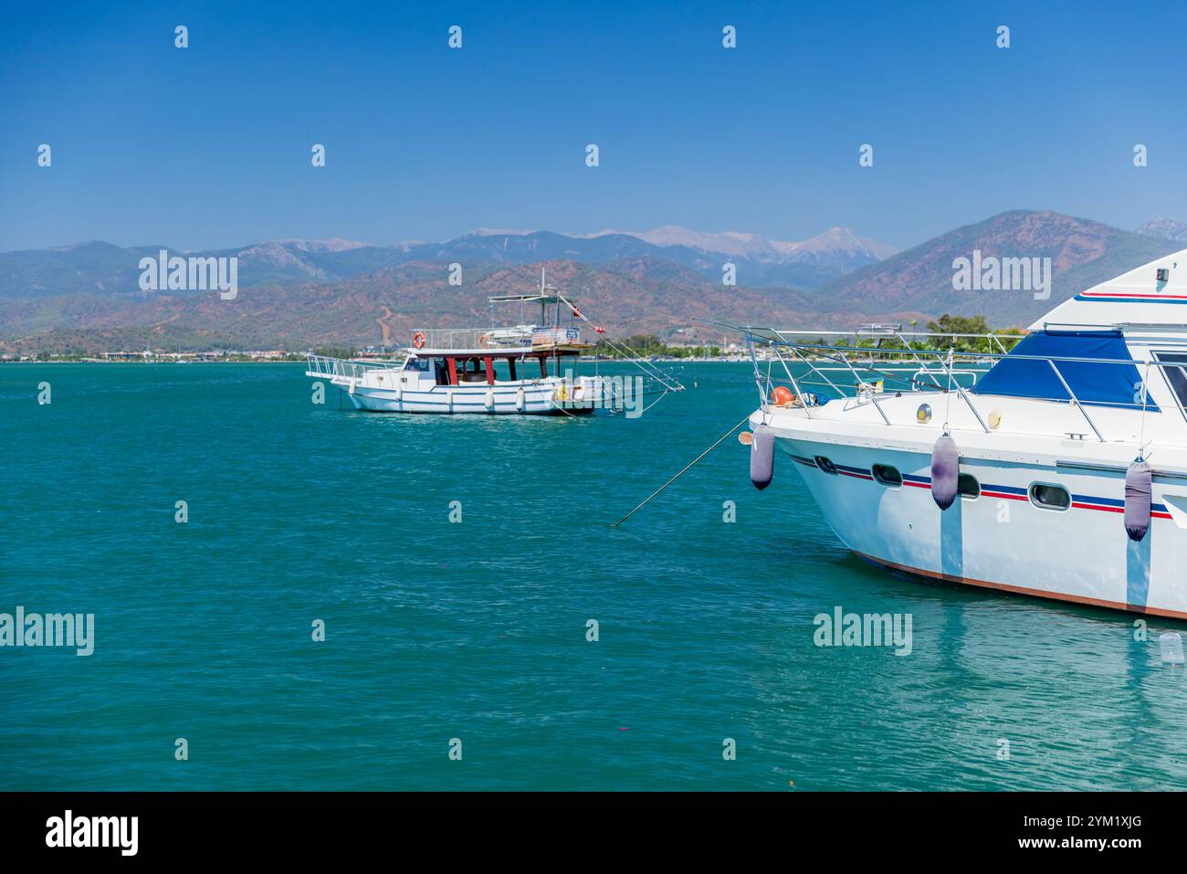 Pleasure motor boats are anchored at Fethiye marina bay on a sunny ...