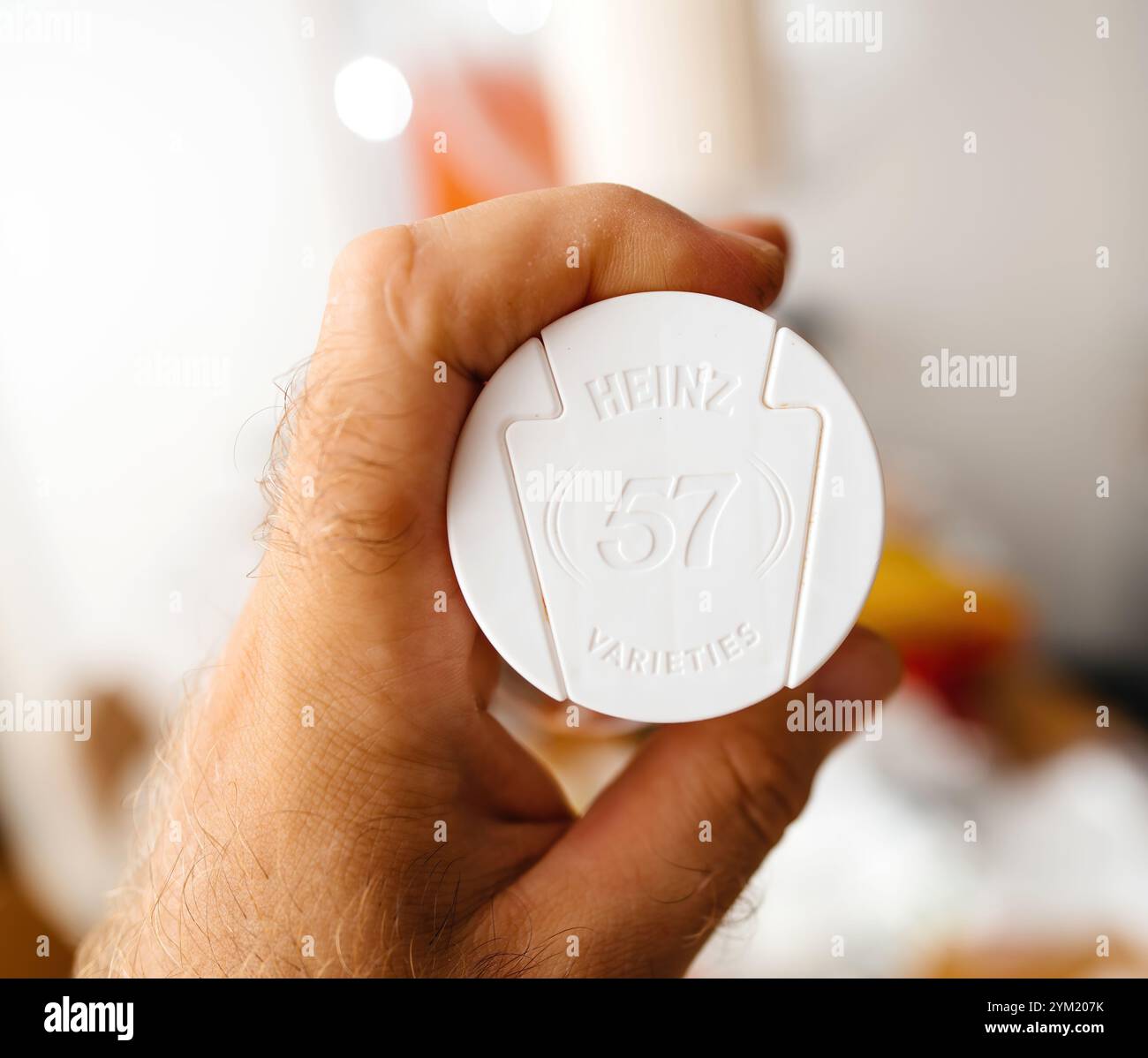 Paris, France - Sep 6, 2024: A hand holding a white Heinz cap embossed ...