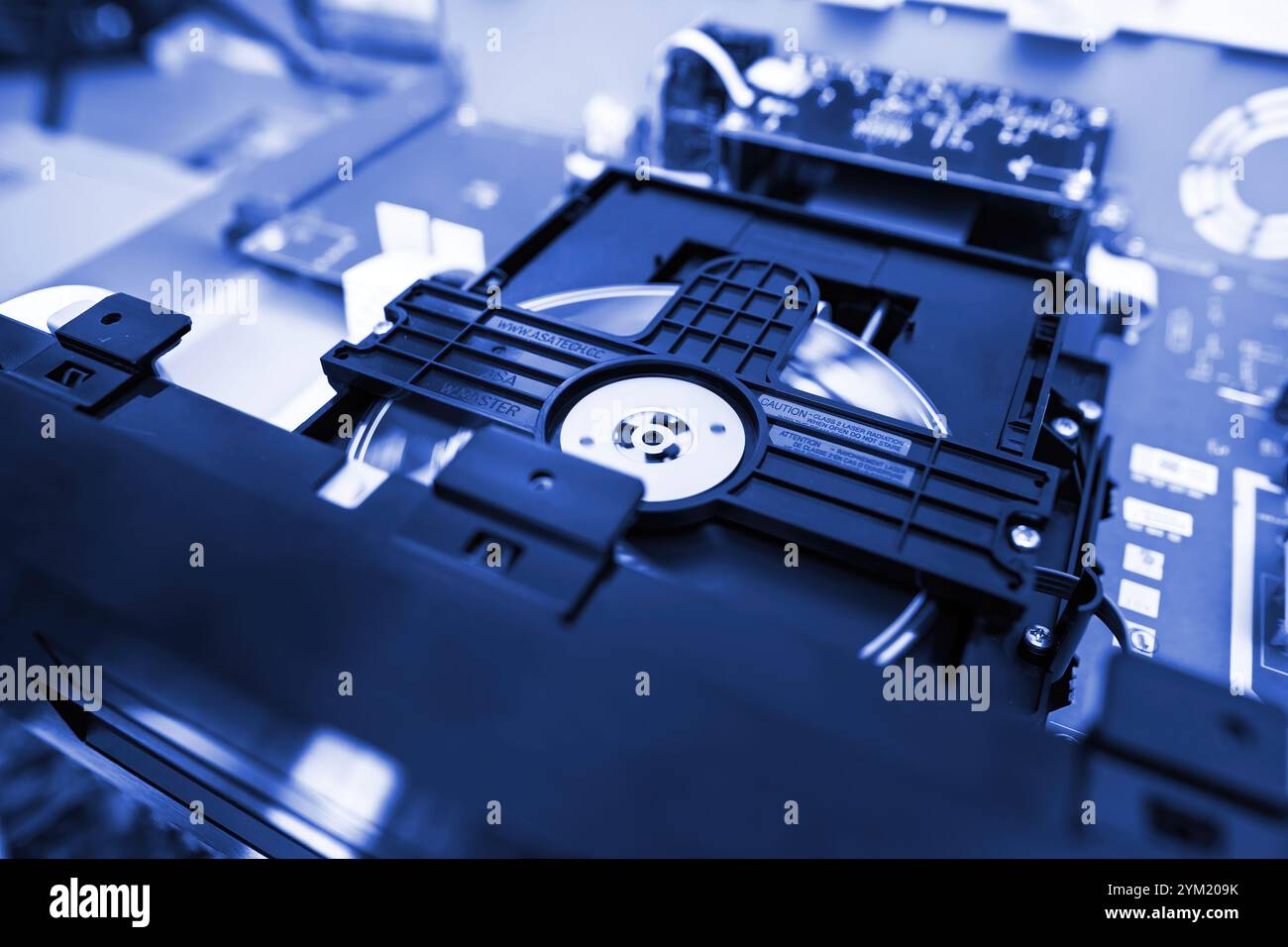 Paris, France - Feb 11, 2023: Open CD DVD drive mechanism in blue-toned ...