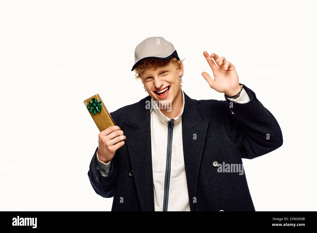 A man showcases his holiday spirit in stylish attire, holding a ...
