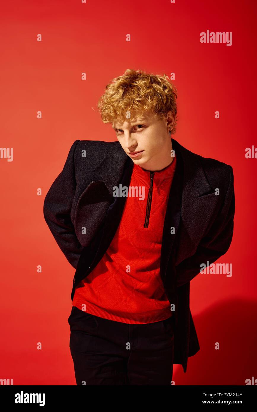 A young man in a striking red outfit combines modern elegance with ...
