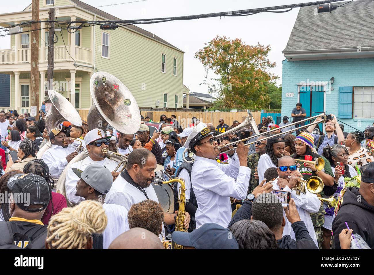 A Second Line parade moving through the streets of the Treme ...