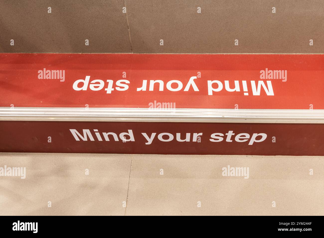 Closeup on Mind your step precaution message printed on step on ...