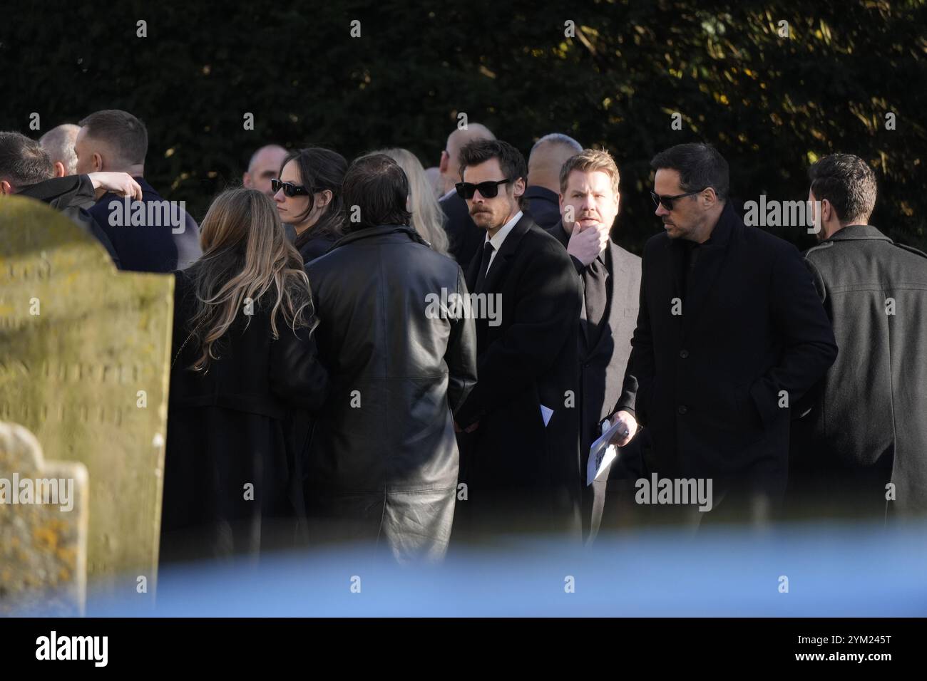 Harry Styles (centre) and James Corden (third right) after the funeral ...
