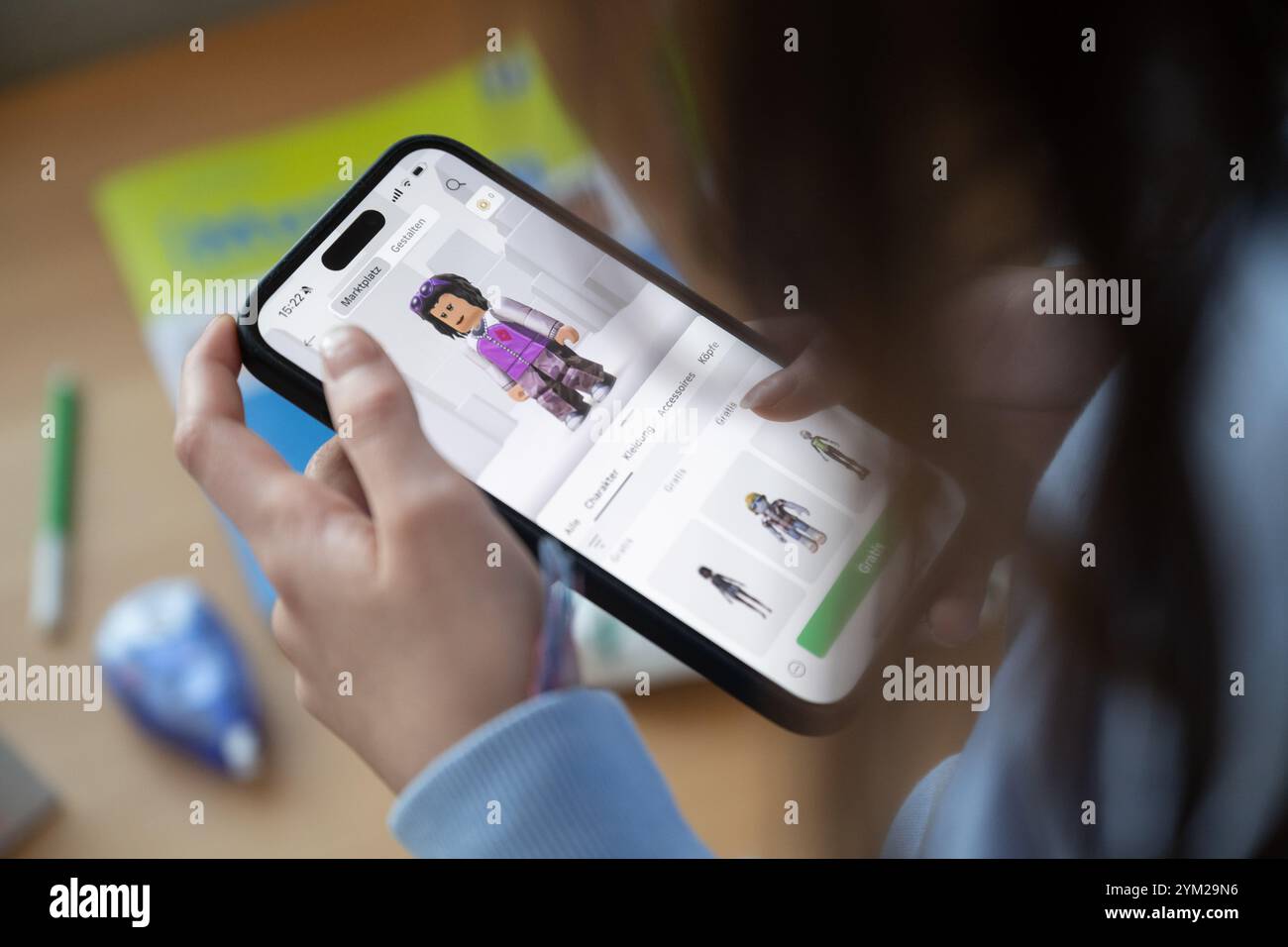 Stuttgart, Germany. 20th Nov, 2024. A girl operates a smartphone on ...