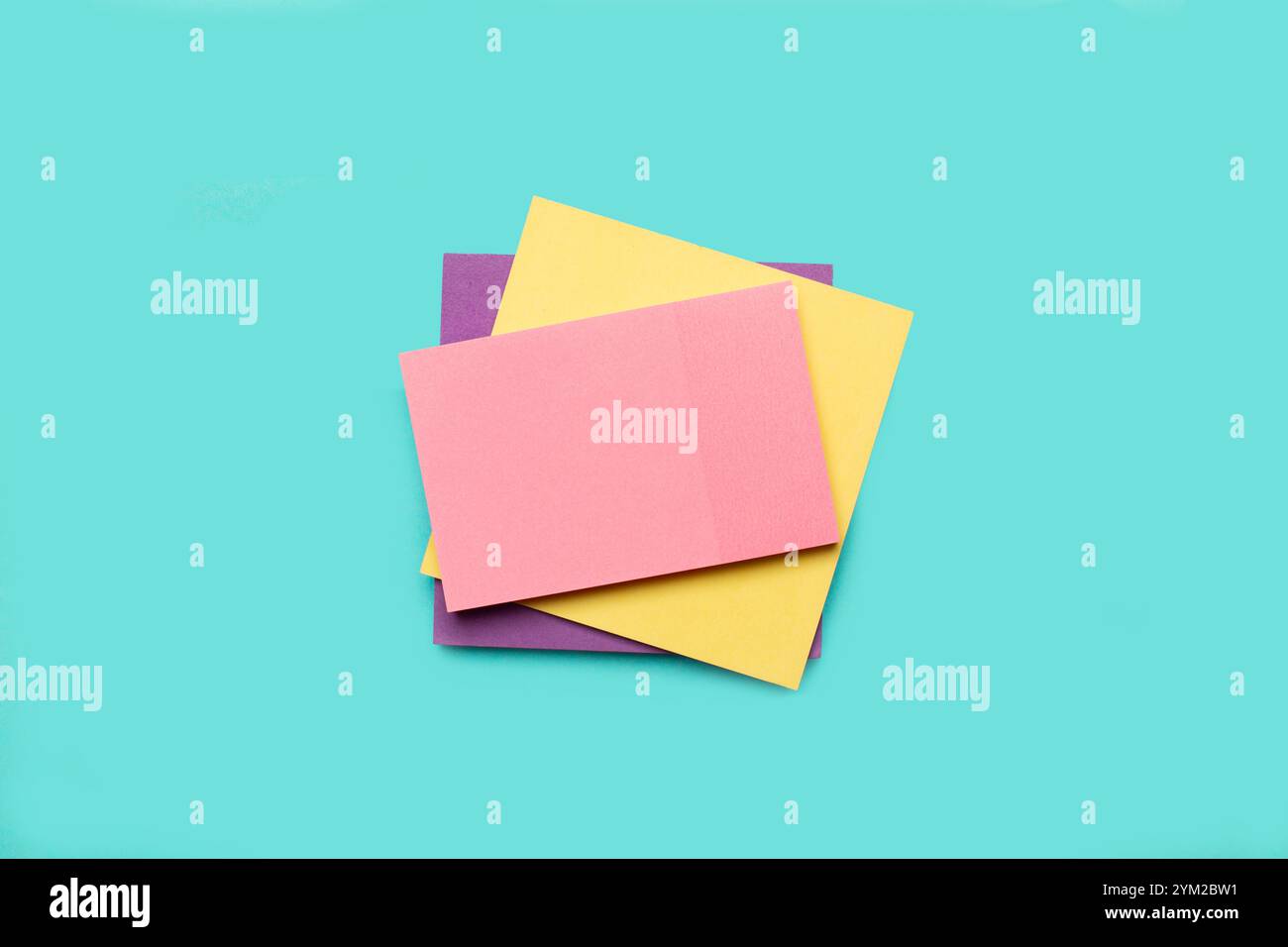 A pile of colored paper notes on a light blue background Stock Photo ...