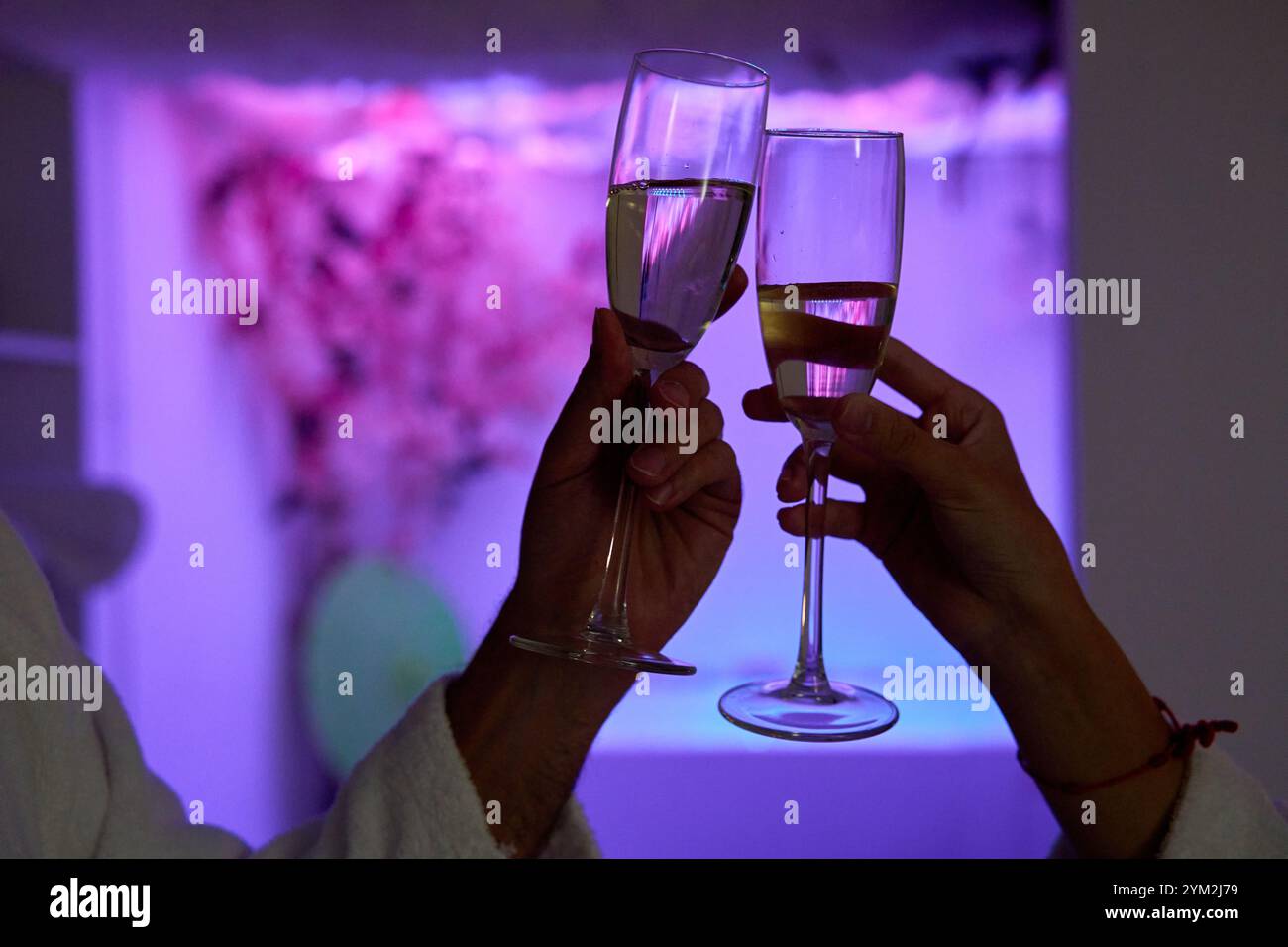 Romantic toast with champagne glasses in a softly lit spa Stock Photo ...