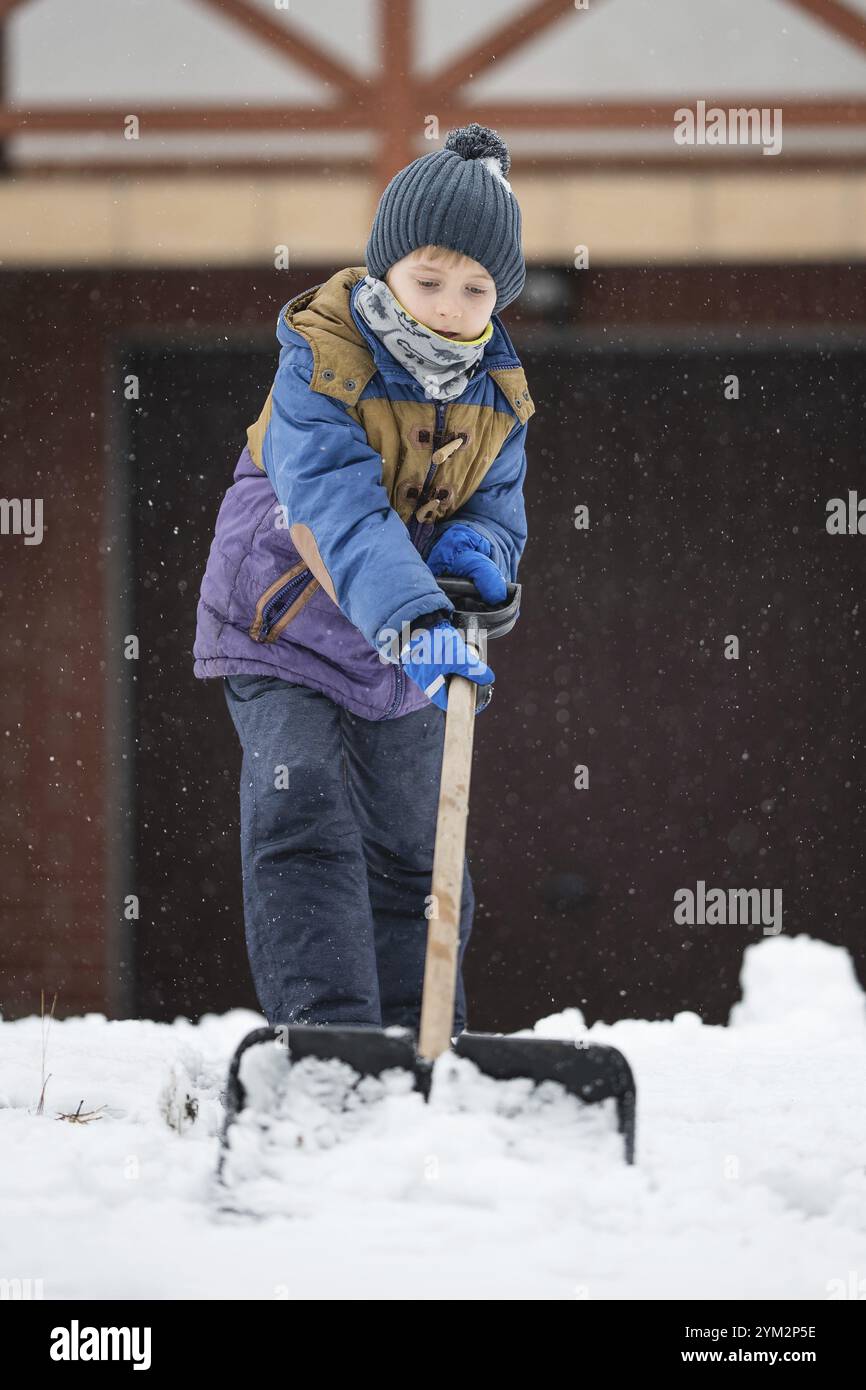 Little boy ploughs the drive Stock Photo - Alamy