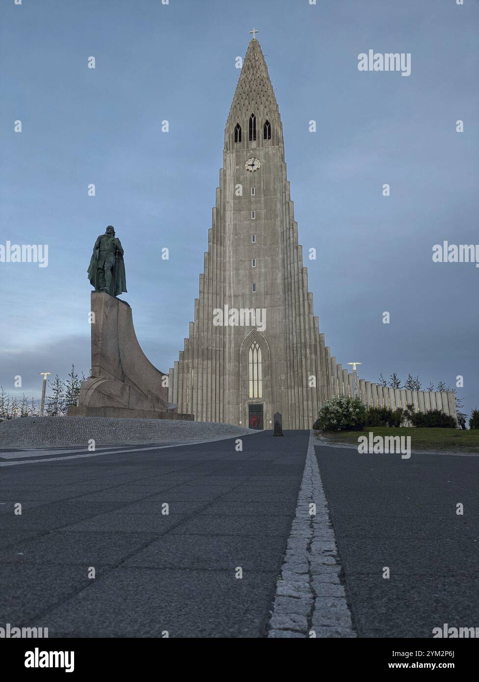 Tall church with distinctive architecture, statue in front, and an ...
