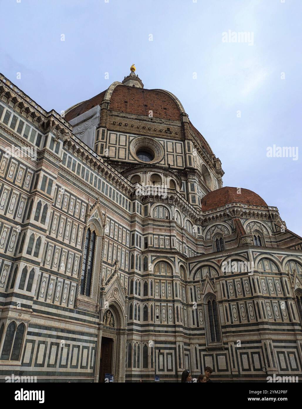 Florence Cathedral with its intricate marble facade and iconic red dome ...