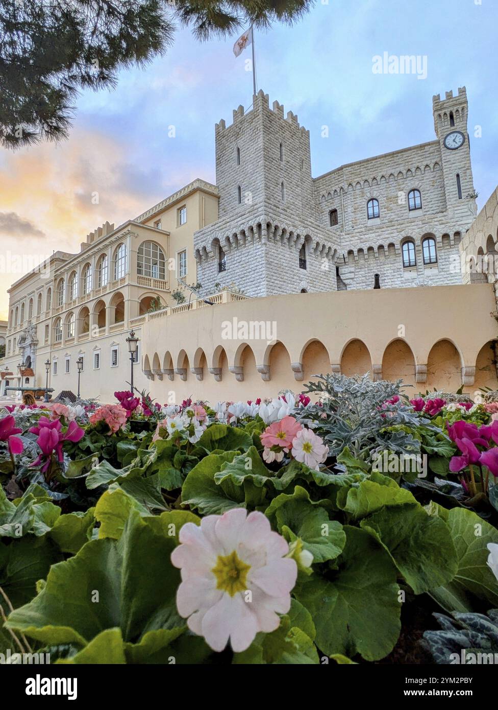 Castle with historic architecture and a garden of blooming flowers ...