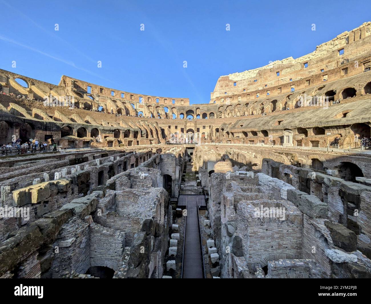 Interior view of the Colosseum showing its ancient stone arches under a ...