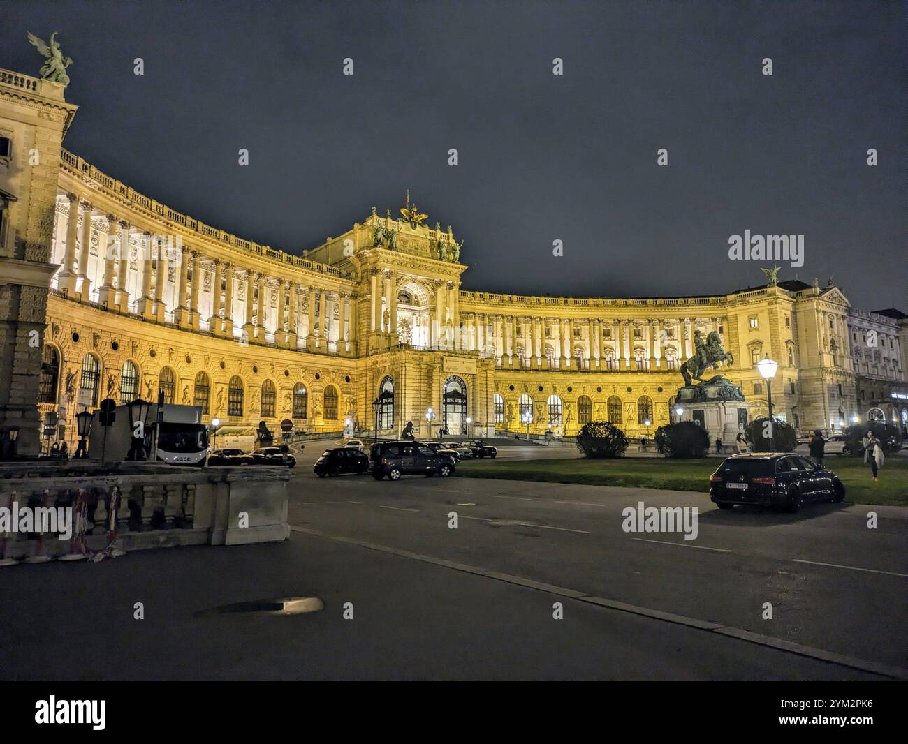 Illuminated grand architecture at night, featuring statues and a ...
