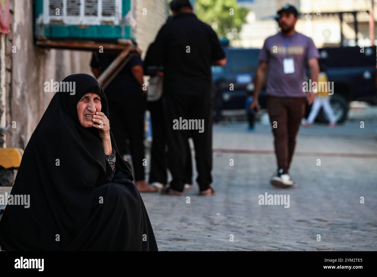 Baghdad, Iraq. 20th Nov, 2024. An elderly Iraqi woman sits on the ...