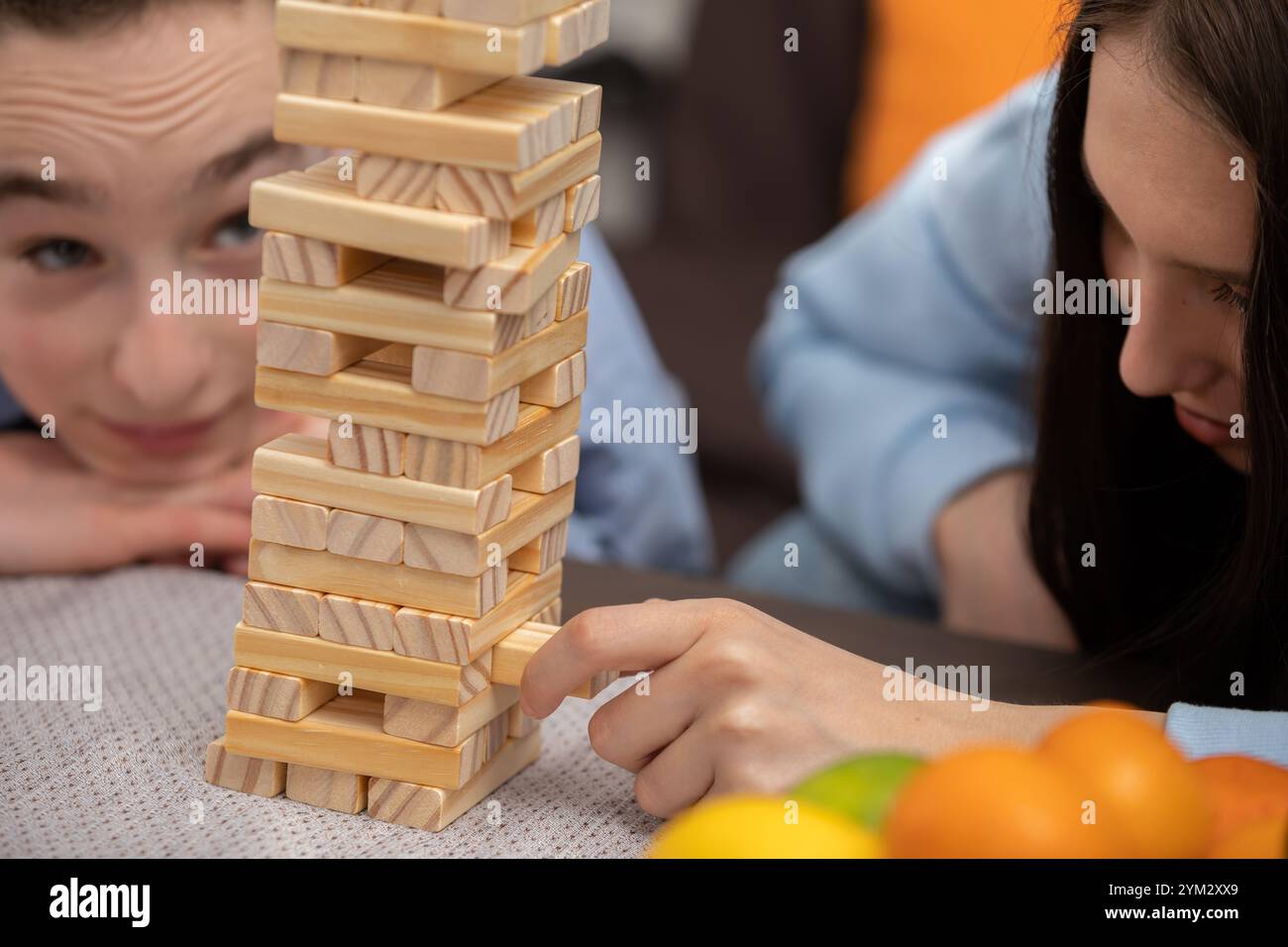 An intense Jenga game taking place among friends creates unforgettable ...