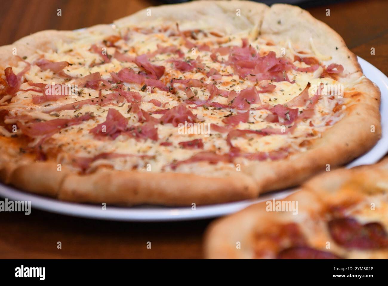 Italian ham and cheese pizza with crispy crust topped Stock Photo - Alamy