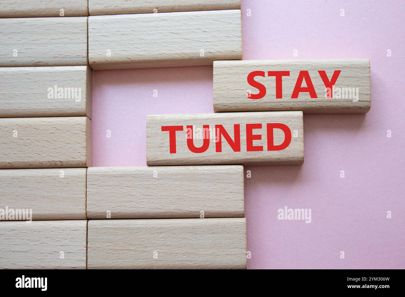 Stay Tuned symbol. Wooden blocks with words Stay Tuned Beautiful pink ...