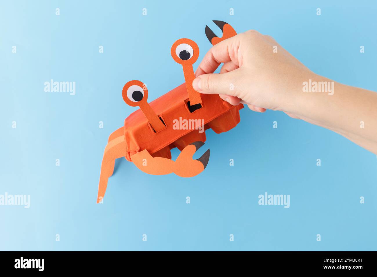 step in creative process, hand attach paper details for legs, claws ...