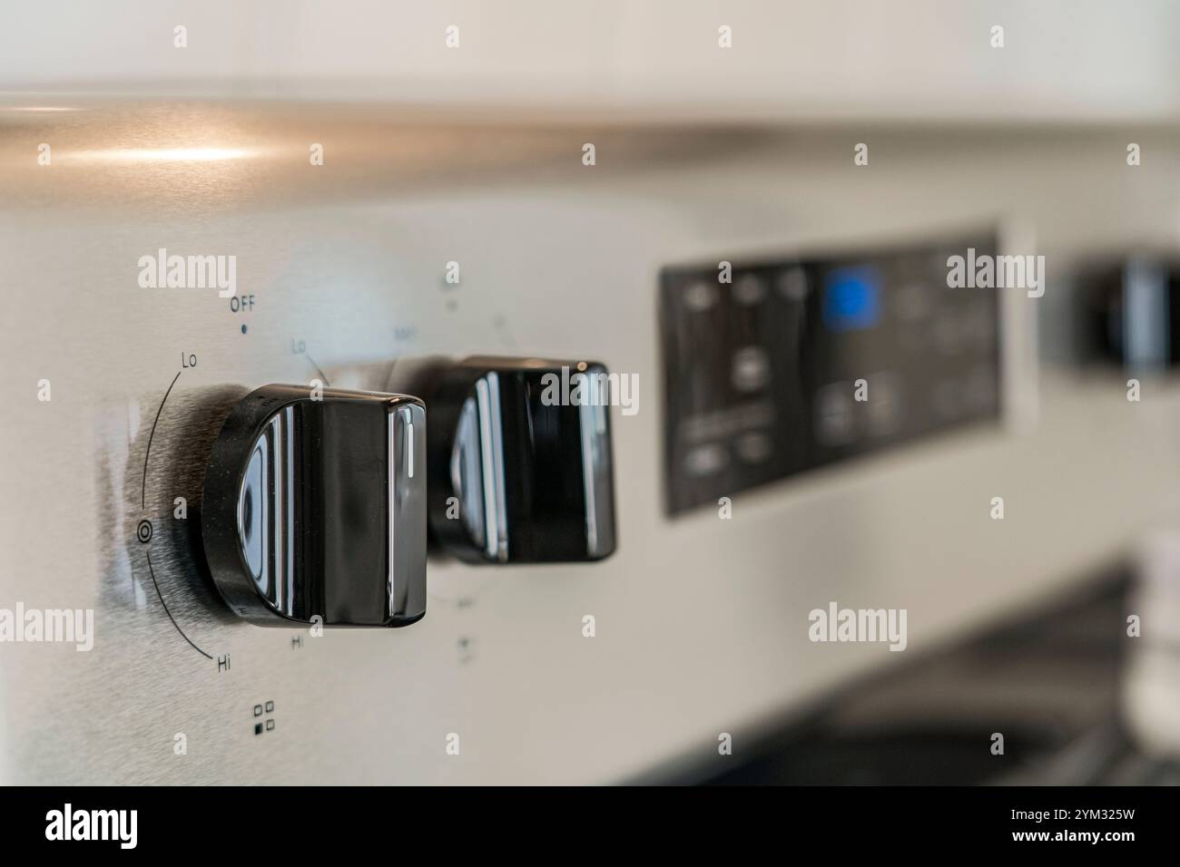 A silver stove with a black knob on the top left. The knob is labeled ...