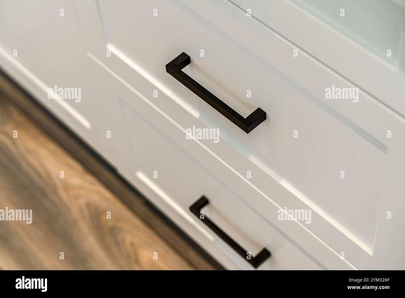 The drawer handles are black and the drawer is white. The handles are ...