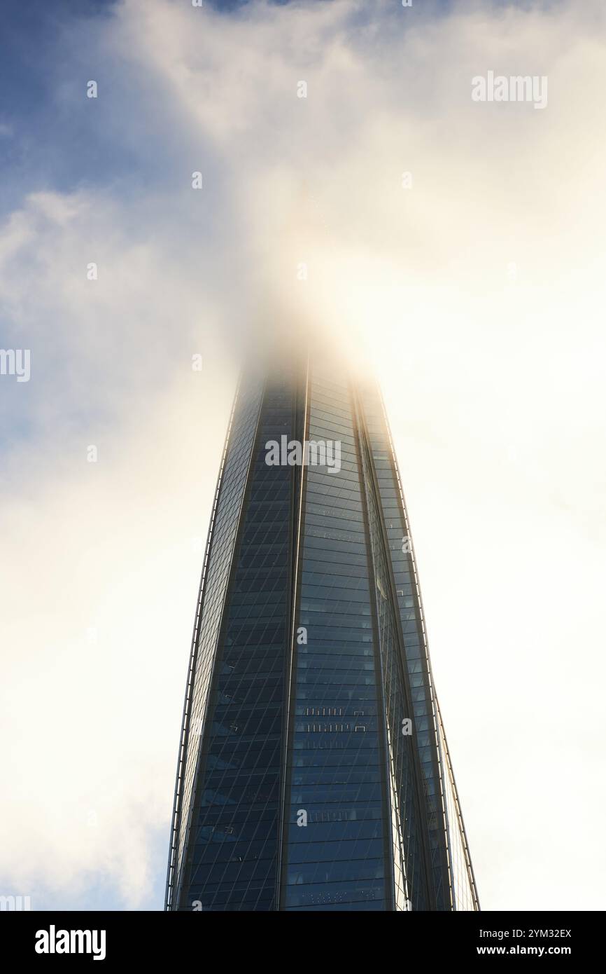 Imposing skyscraper reaching into clouds with modern architecture and ...