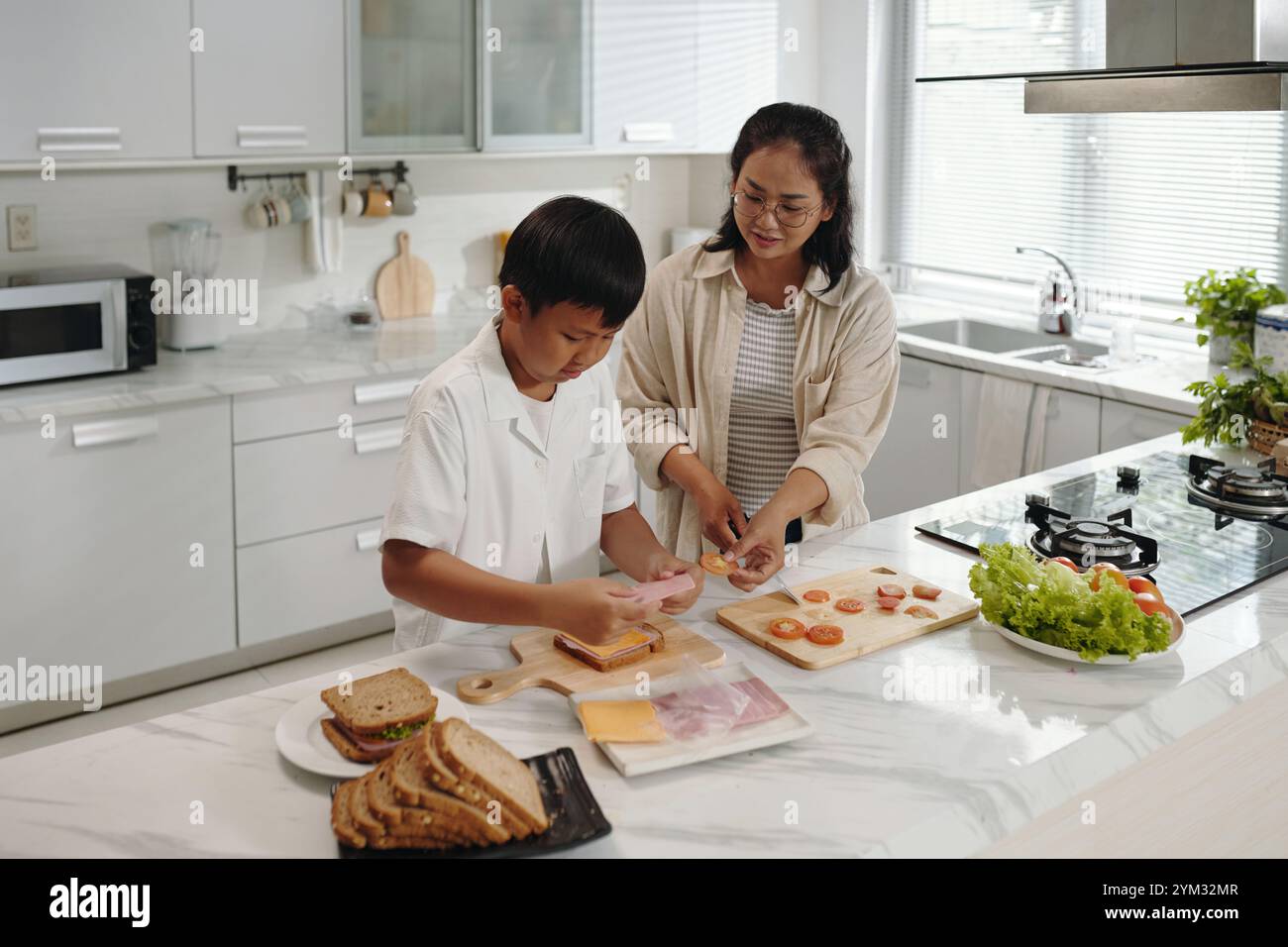Preparing Sandwiches Together in Modern Kitchen Stock Photo - Alamy