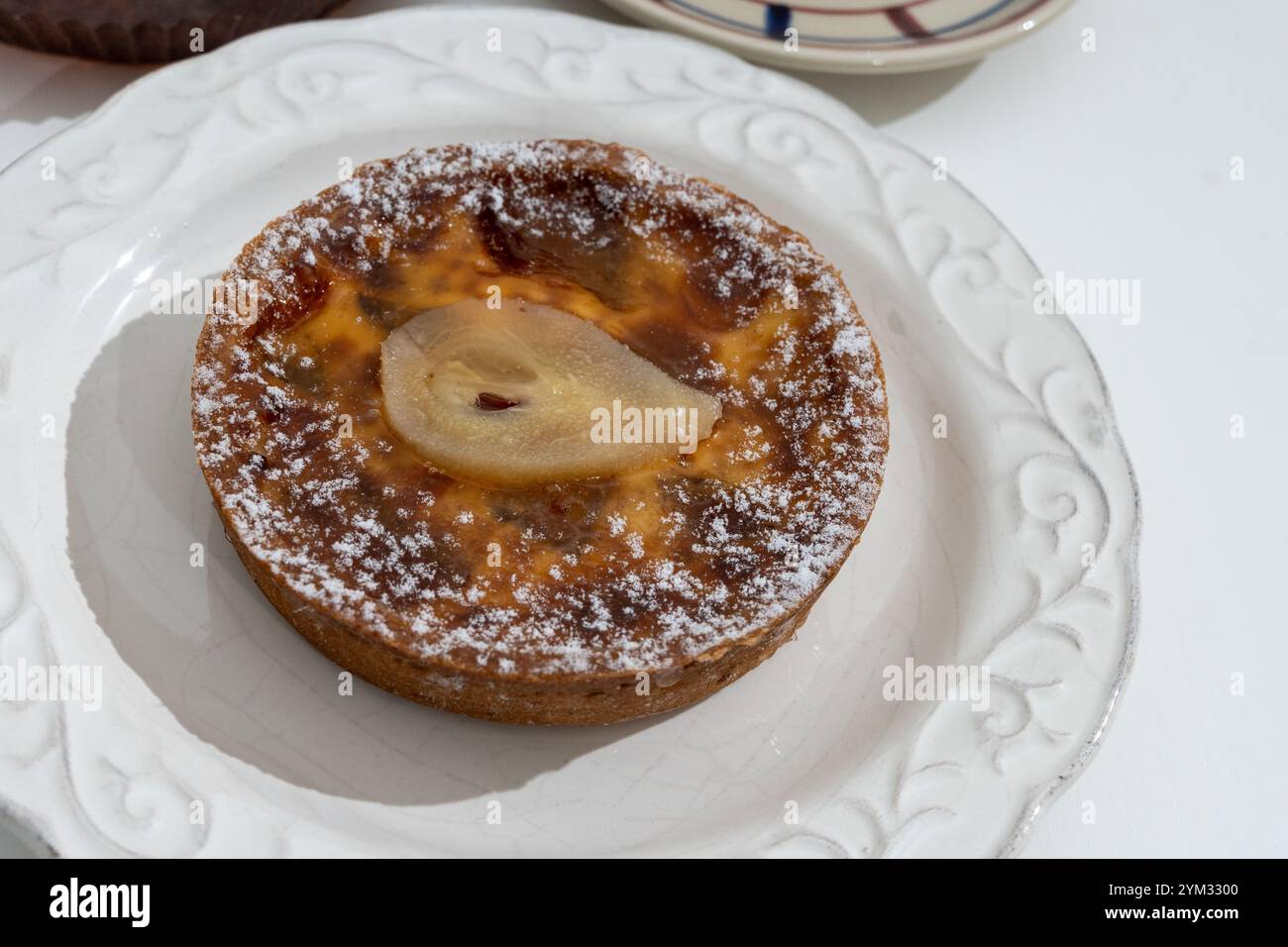 Homemade baked pear cake with caramel almond custard close up ...