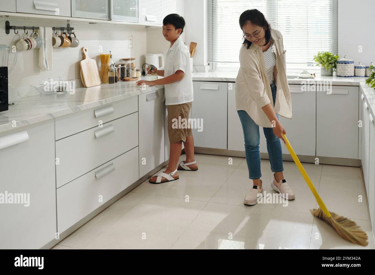Mother and Son Cleaning Kitchen Together in Morning Stock Photo - Alamy