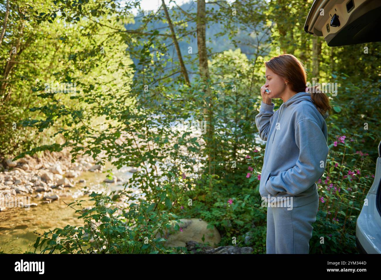 Woman Camping in the Forest, Brushing Teeth by a Car on a Peaceful ...