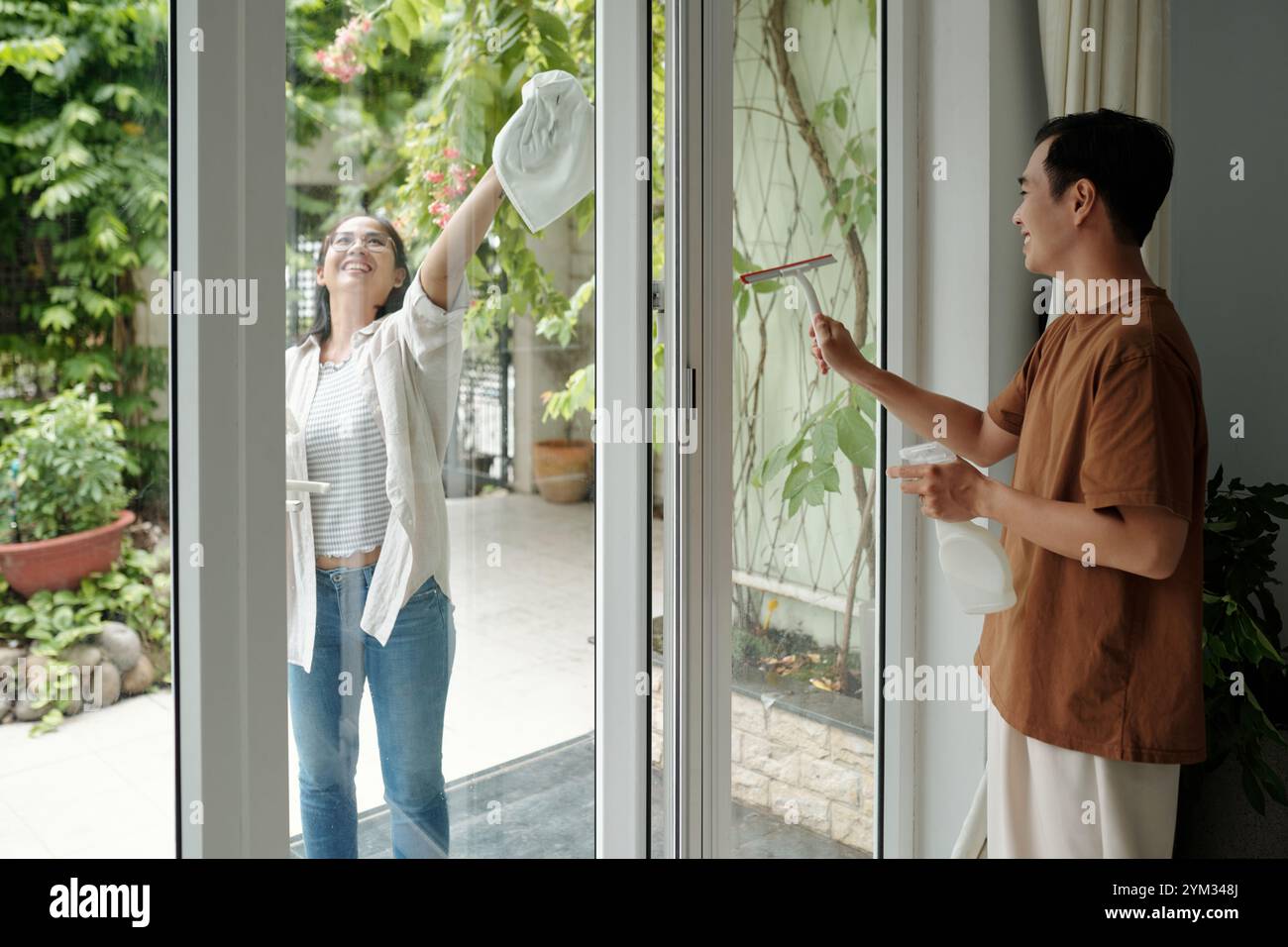 Cleaning Windows Together in a Bright Natural Light Setting Stock Photo ...