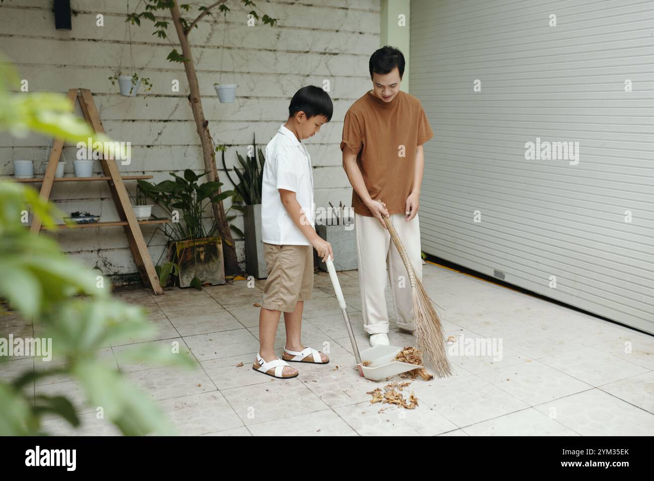 Boy sweeping ground hi-res stock photography and images - Alamy