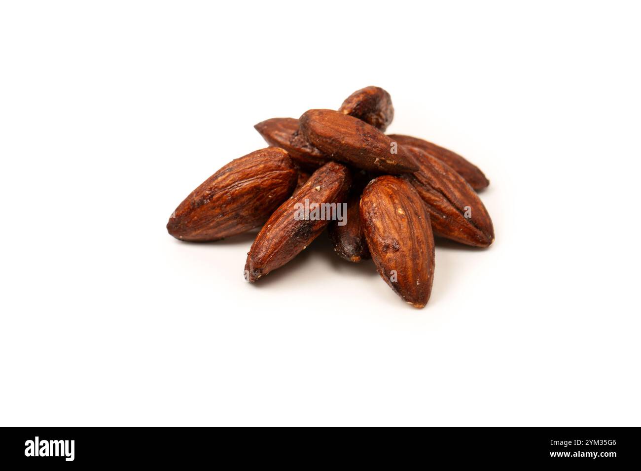 A group of caramelized almonds isolated on a white background Stock ...
