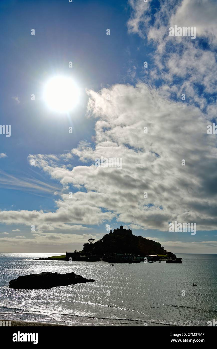 Silhouette of St Michaels Mount with white clouds and blue sky and a ...