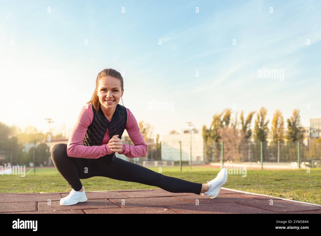 Athletic young woman exercises outdoors hi-res stock photography and ...