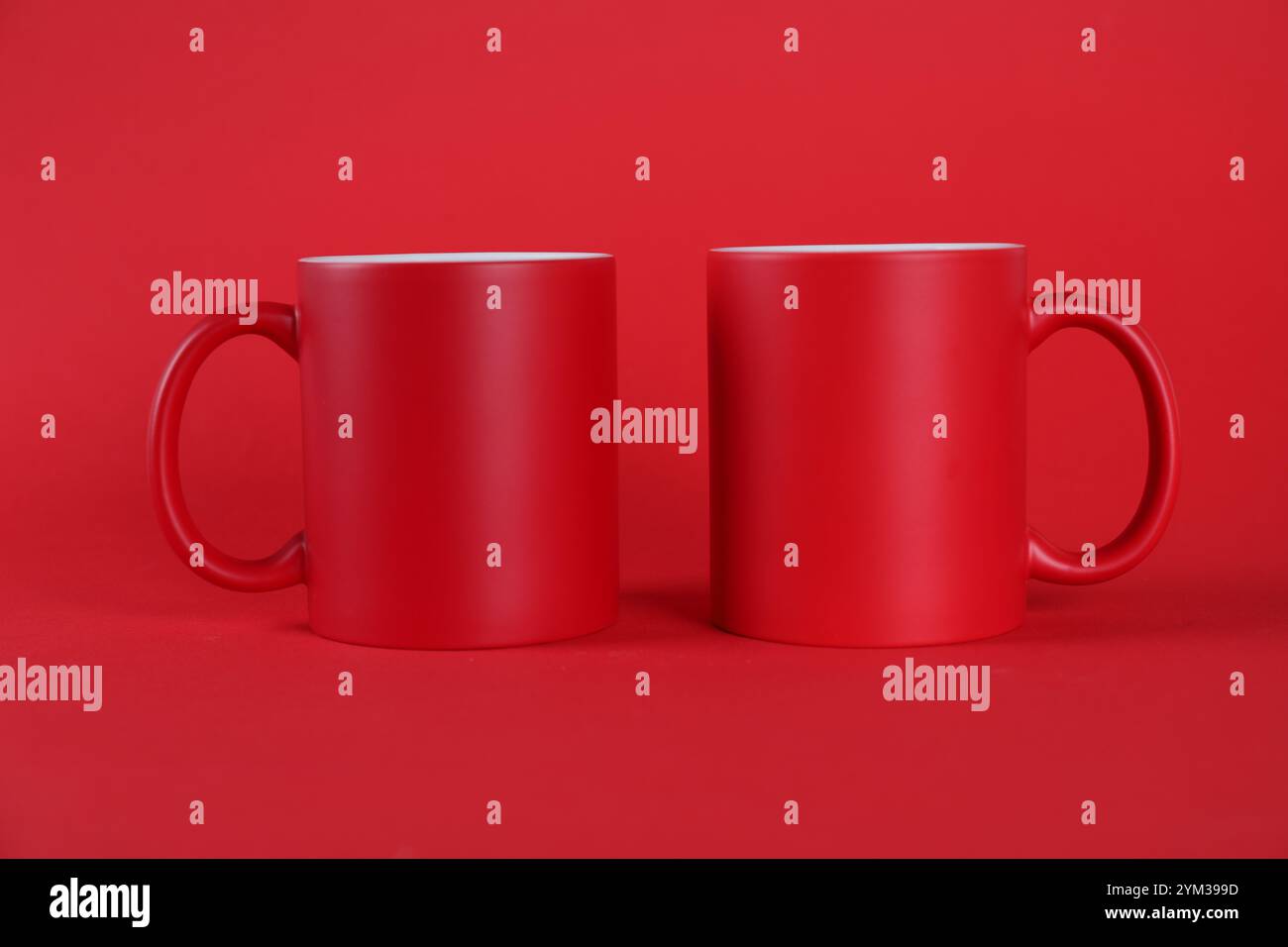 Two blank mugs on red background. Mockup for design Stock Photo - Alamy