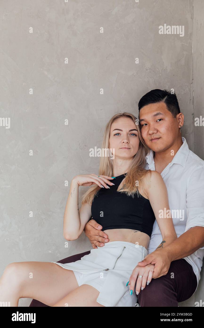 Man And Woman Sitting Together Side By Side Hugging Stock Photo - Alamy