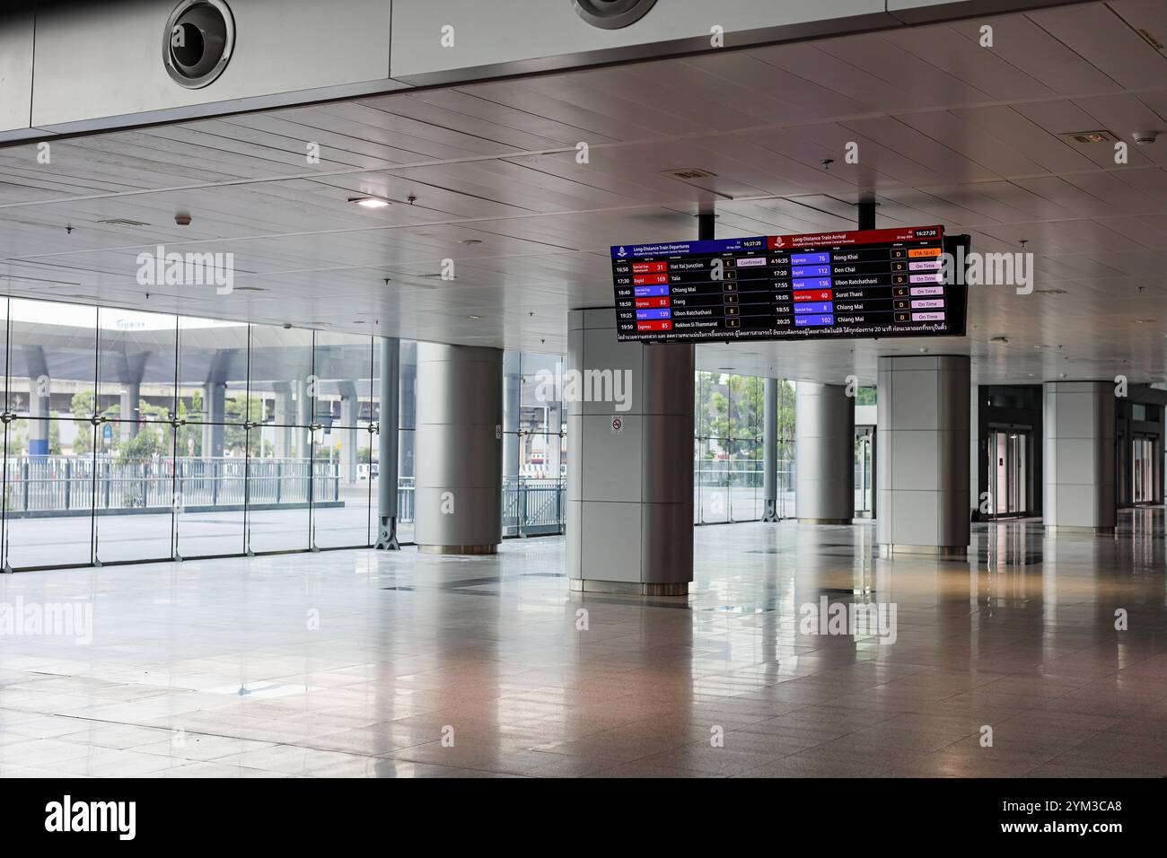 The illuminated long and clean hallway of a modern building serves as a ...