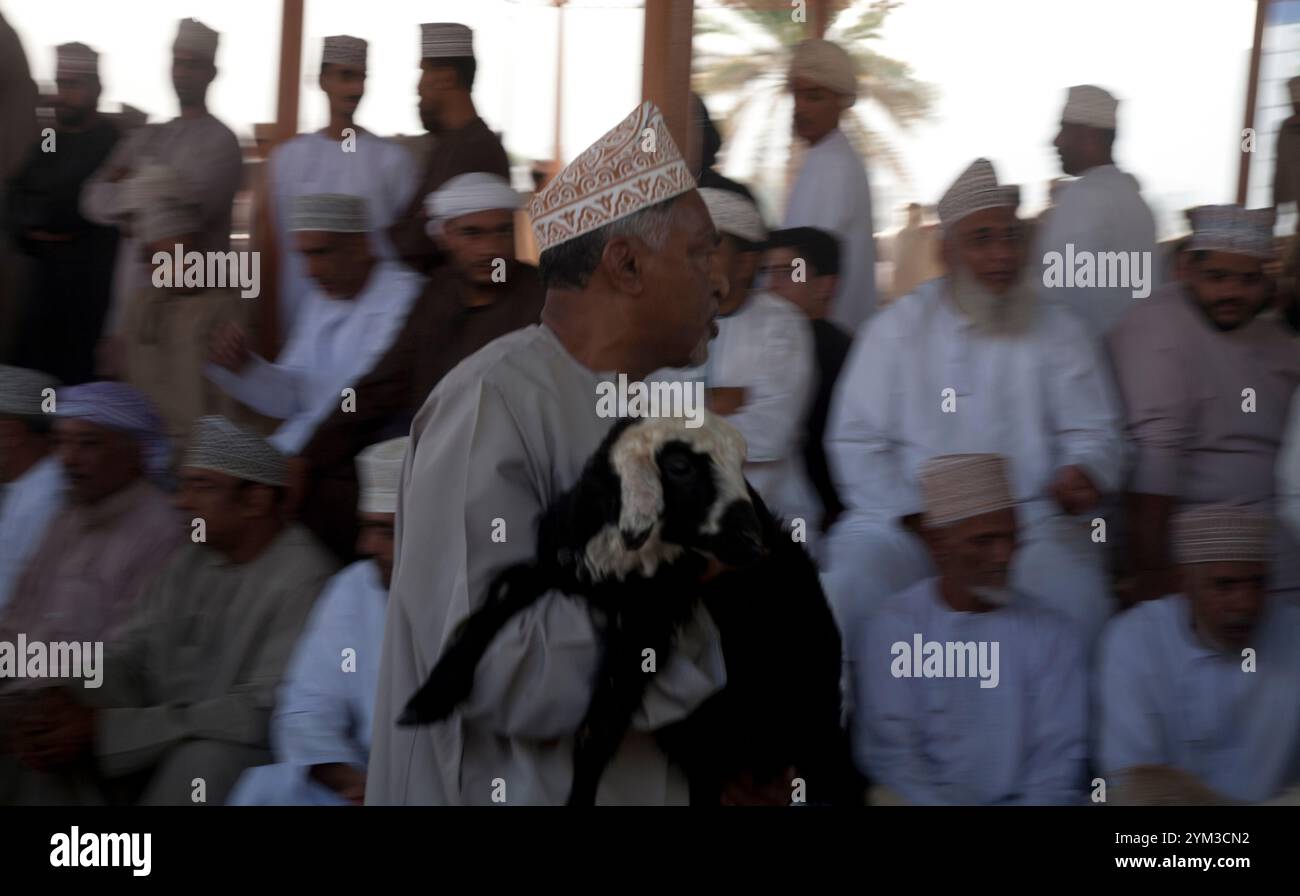 omani man carrying goat at nizwa livestock market nizwa oman middle ...