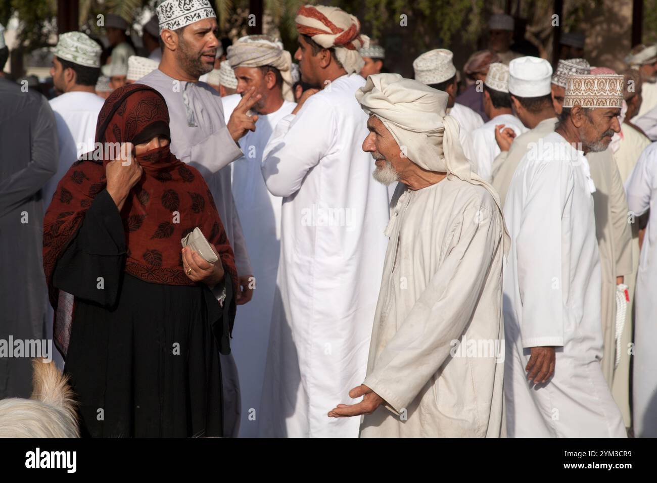 omani man talking to omani woman at nizwa liovestock market oman middle east Stock Photo - Alamy